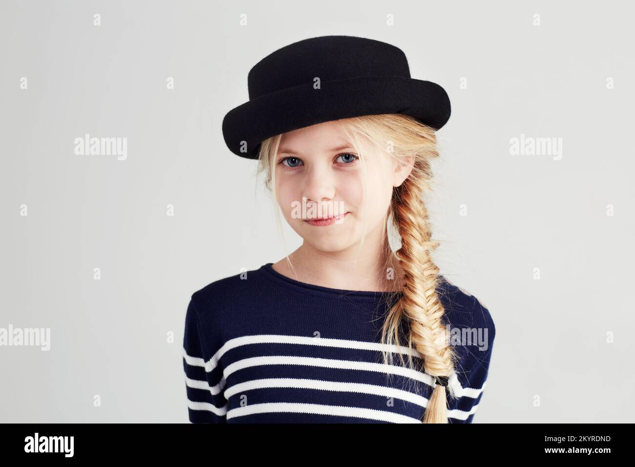 Too cute for her own good. Portrait of a cute girl wearing a hat and ...