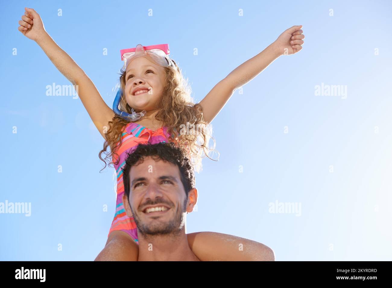 Happy girl sitting on the shoulders of adult male hi-res stock ...