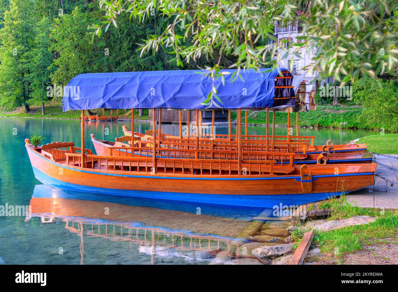 Tourist boats moored on a lake shore in Thailand Stock Photo - Alamy