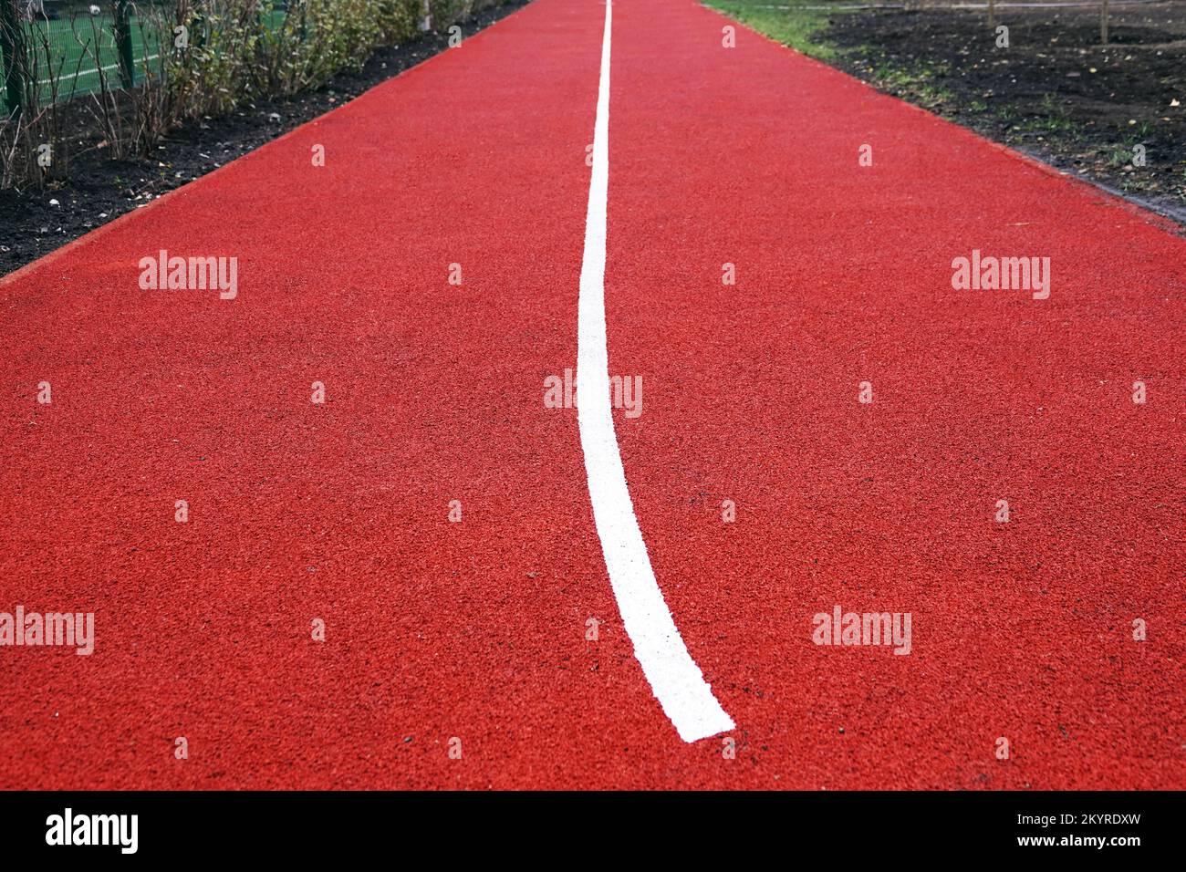 Running track in the park going to the left Stock Photo - Alamy