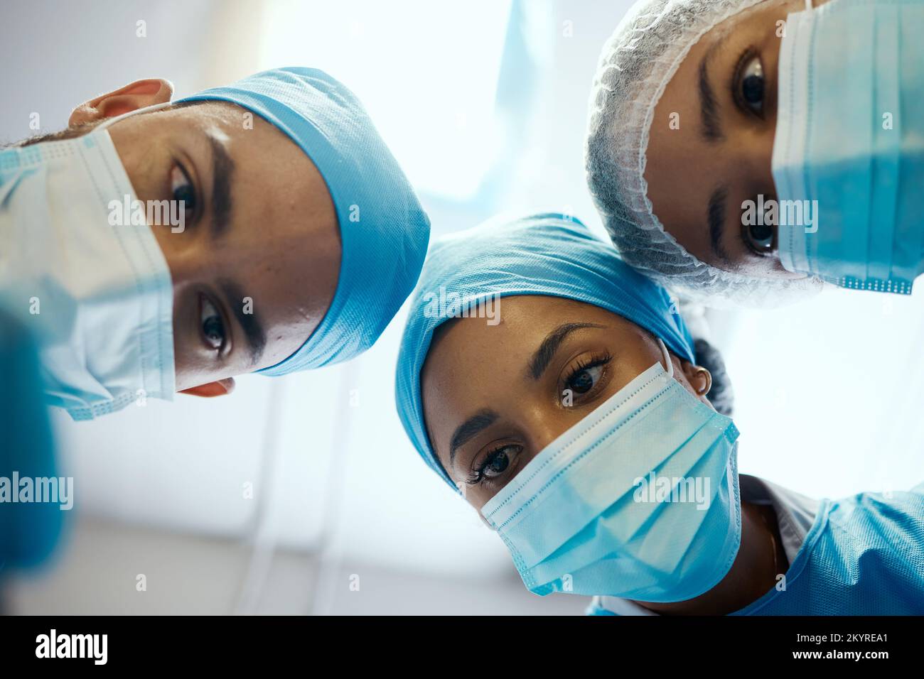 Surgery, face mask and surgeon team during covid working on medical operation for hospital ...