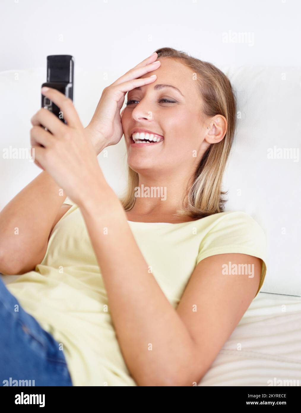 Thats too funny. A laughing woman looking at her cell phone whilst ...