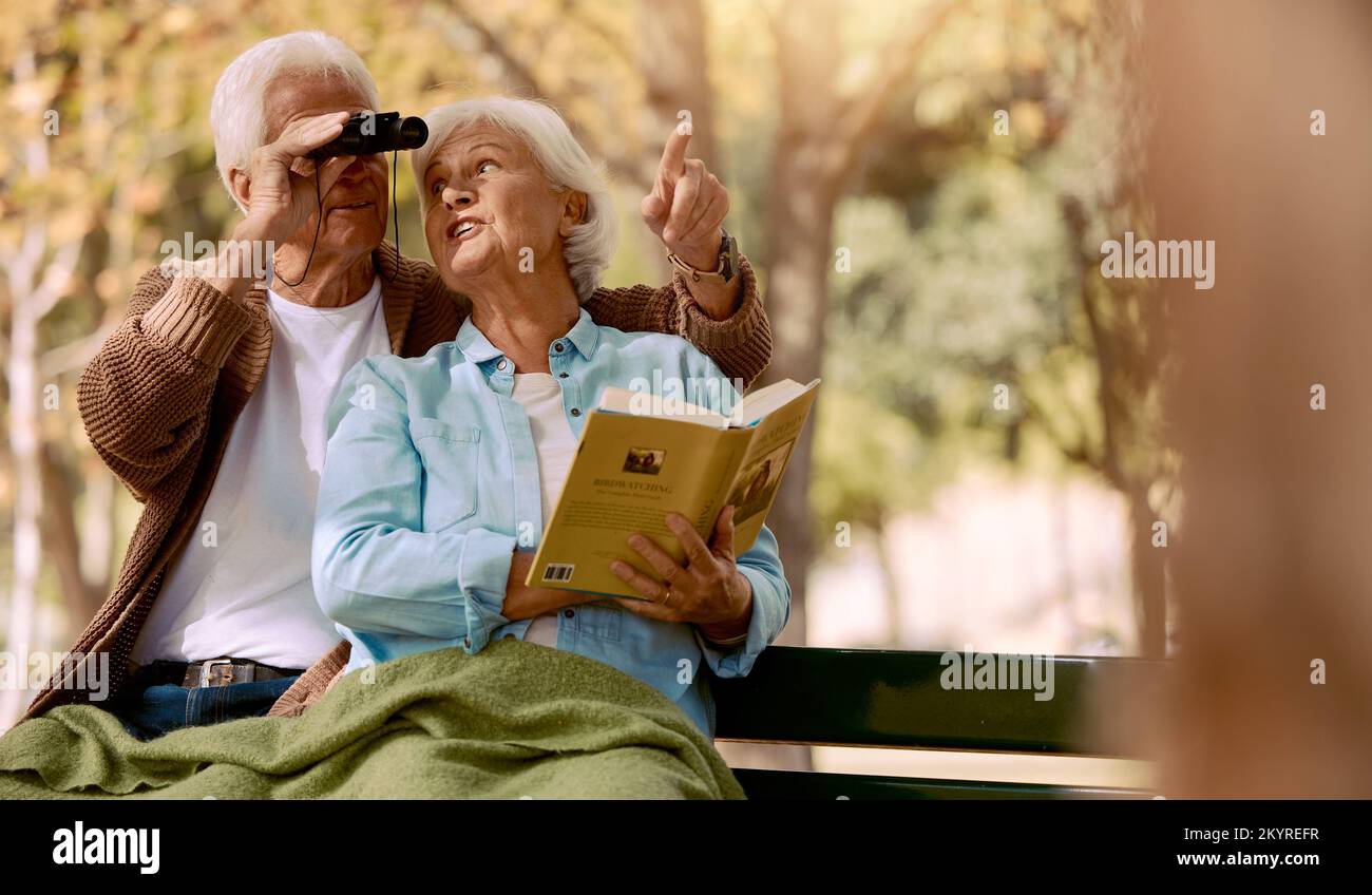 Happy senior couple bird watching in park for relax bonding time ...