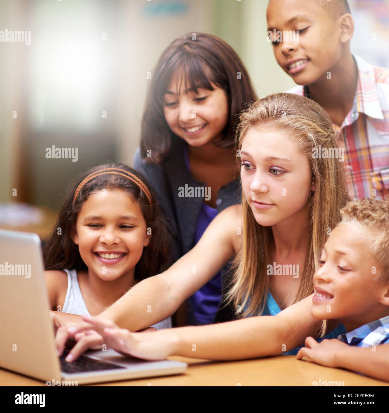 More information, more learning. A group of pupils working on a laptop ...