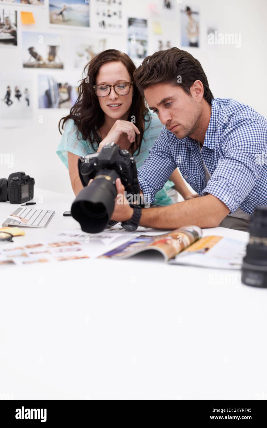 Making his final selection. A photographer looking at his images in his ...