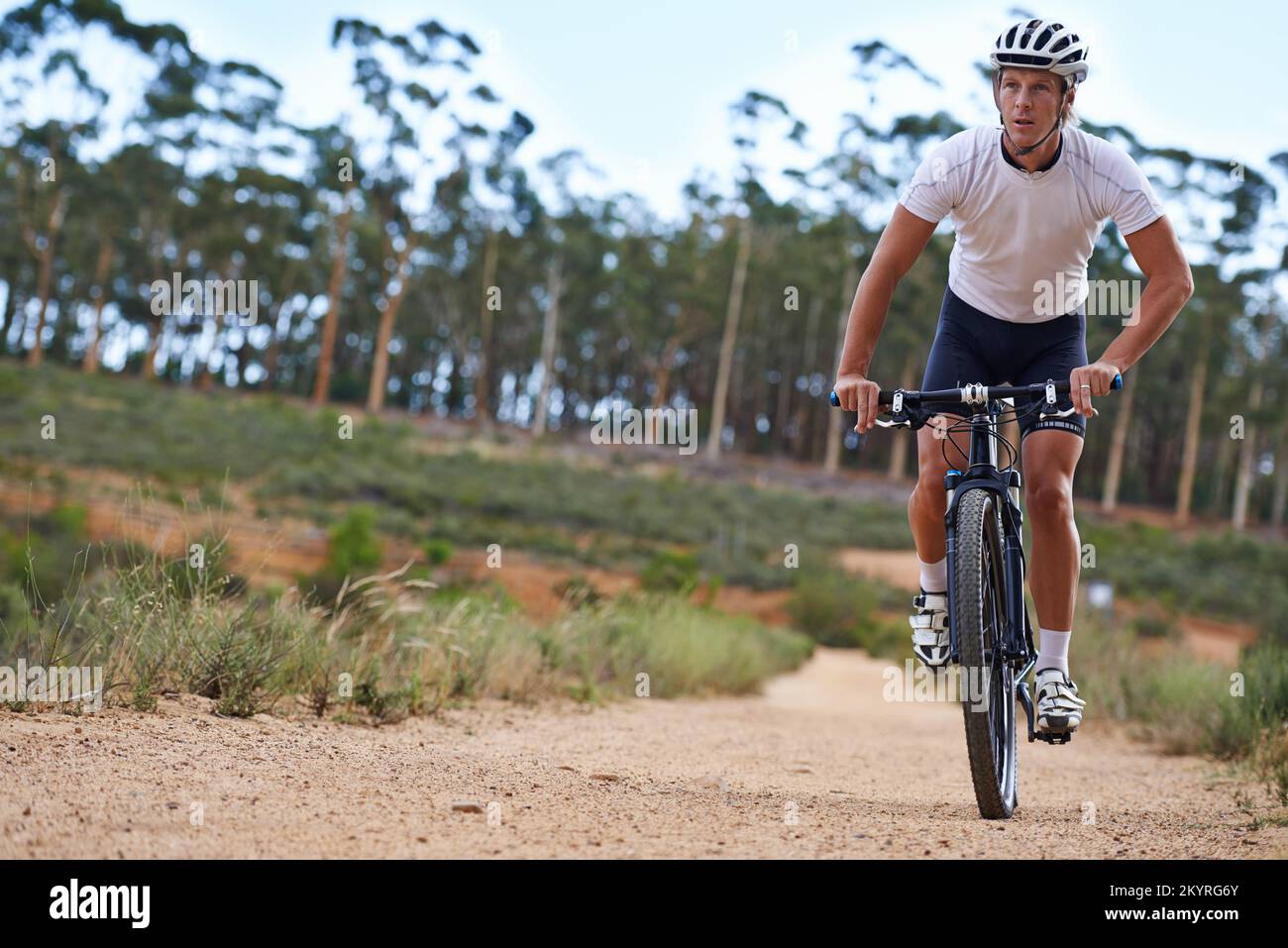 Nothing beats an extreme bike ride. Fit cyclist riding across rough ...