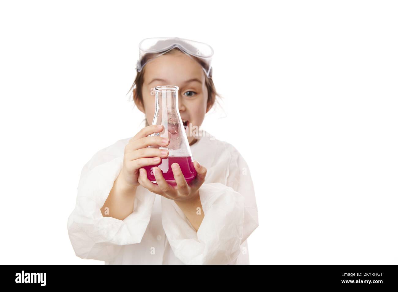 Detail: child's hands holding flat-bottomed flask with purple liquid ...