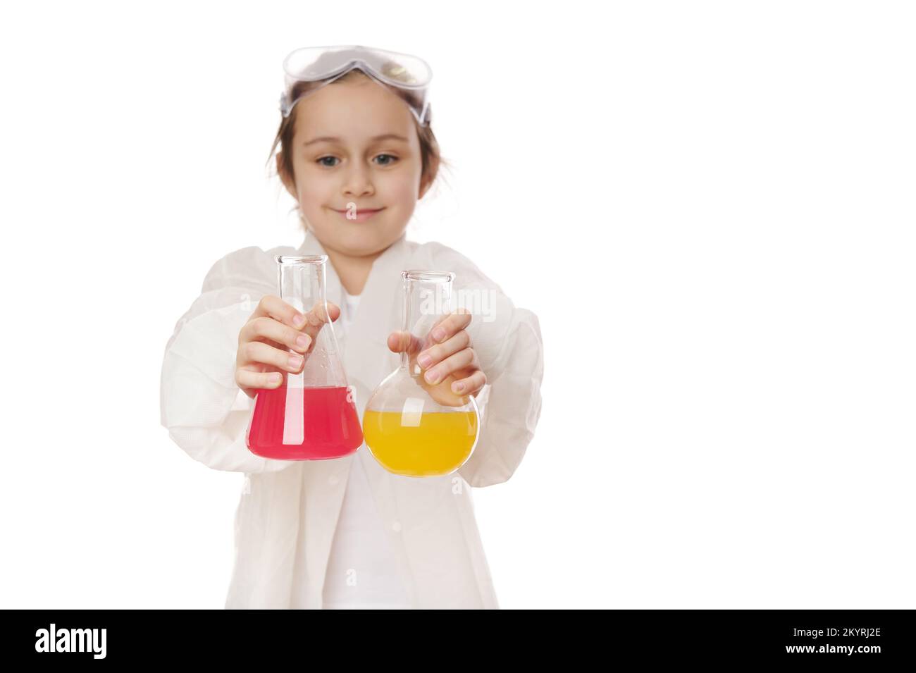 Lab flasks with chemical substances in hands of a little girl, showing ...