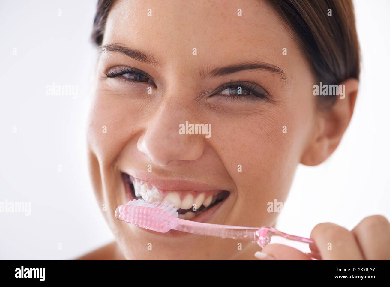 Shes all about dental hygiene. A gorgeous young brunette brushing her ...