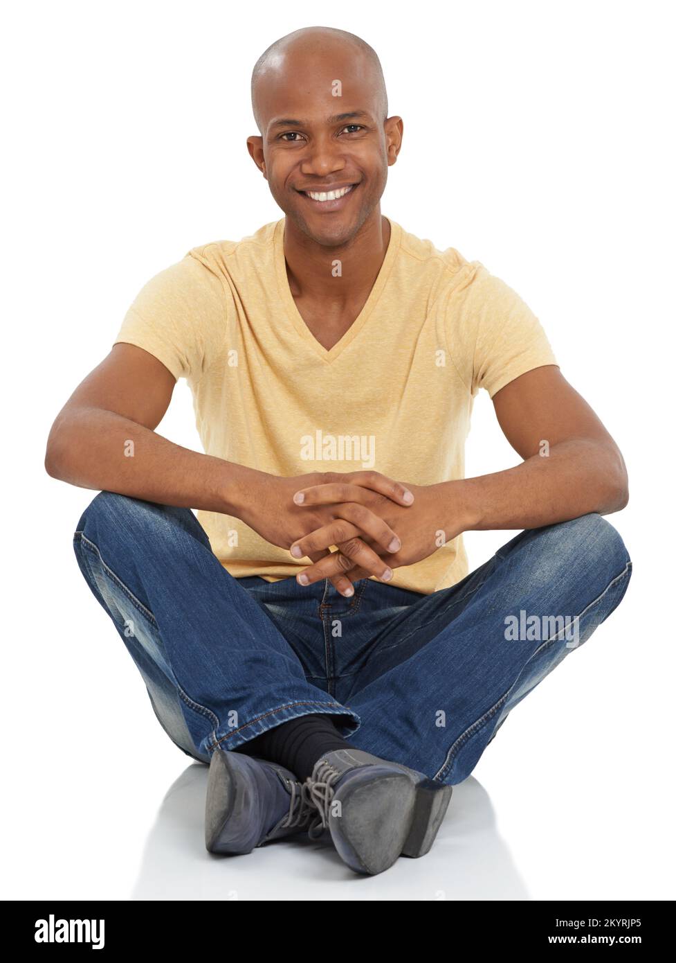 Im happy with who I am. A young ethnic man sitting crossed legged and ...
