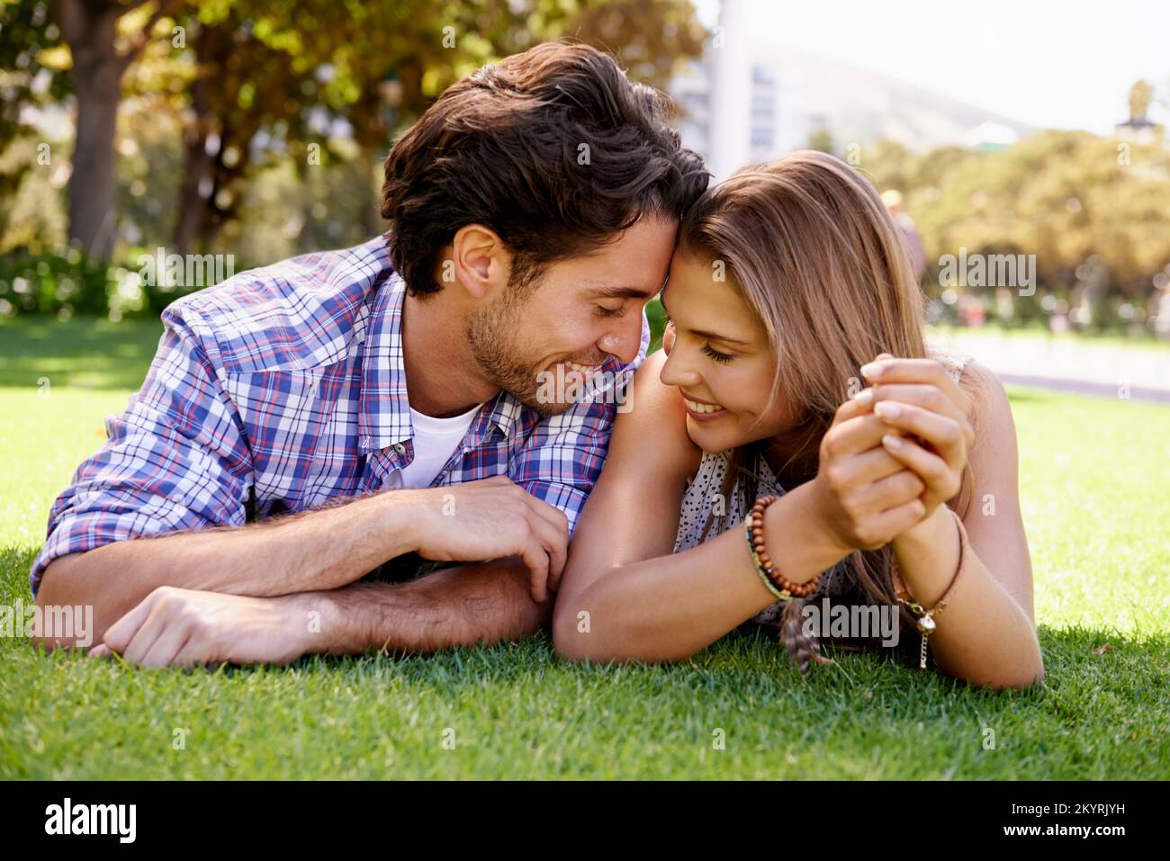 Romance comes naturally to them. a happy young couple lying on the ...