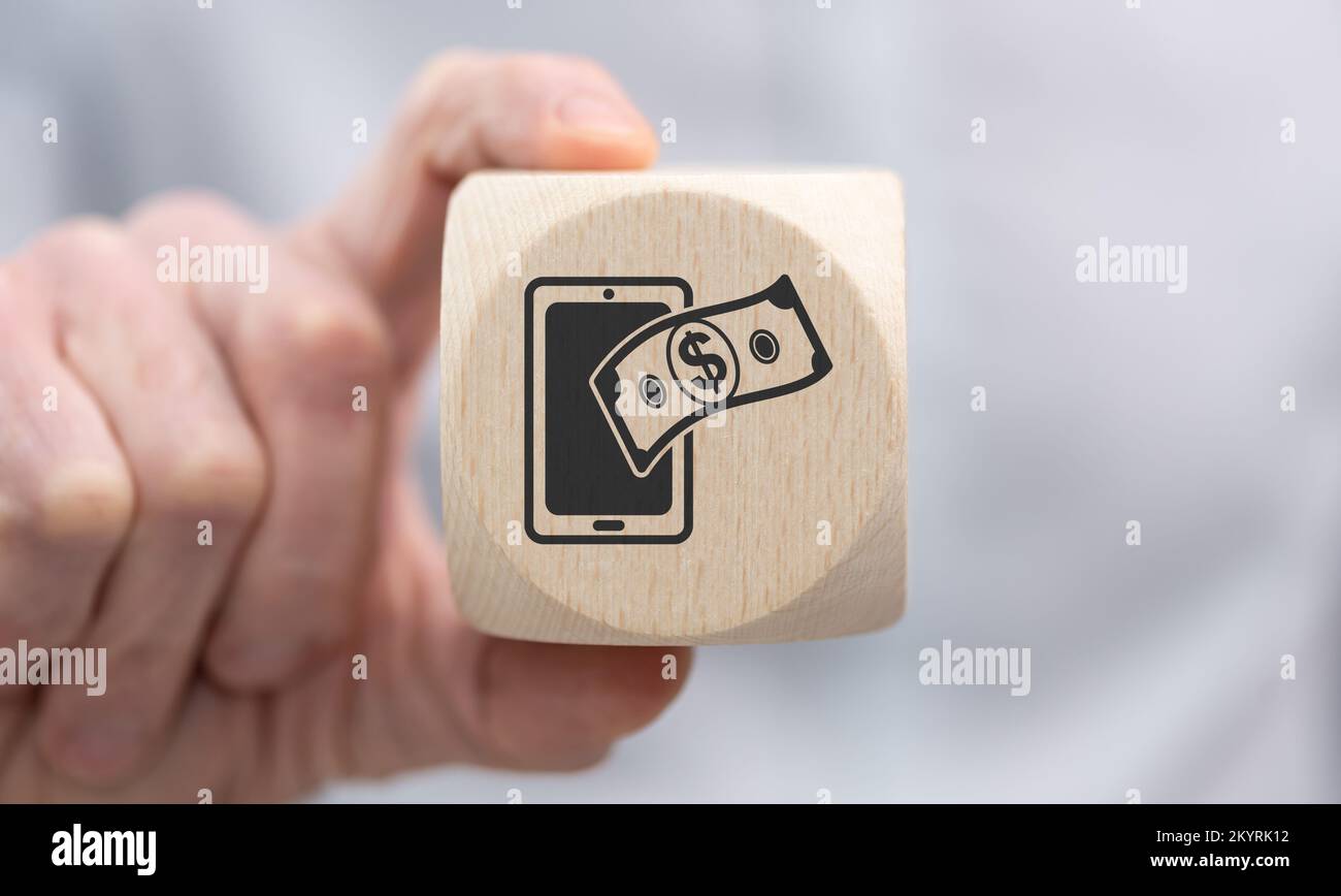 Hand holding a wooden cube with symbol of mobile payment concept Stock ...