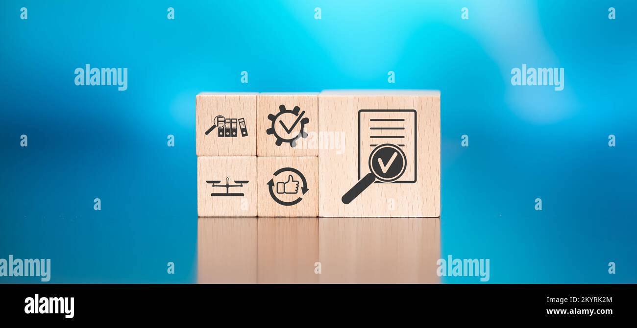 Wooden blocks with symbol of assessment concept on blue background ...