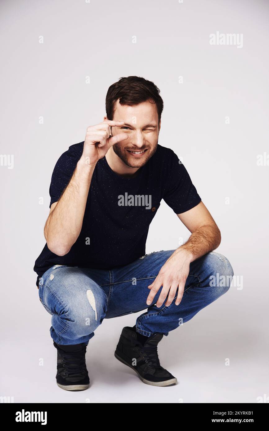 Slim man 20s crouching hi-res stock photography and images - Alamy