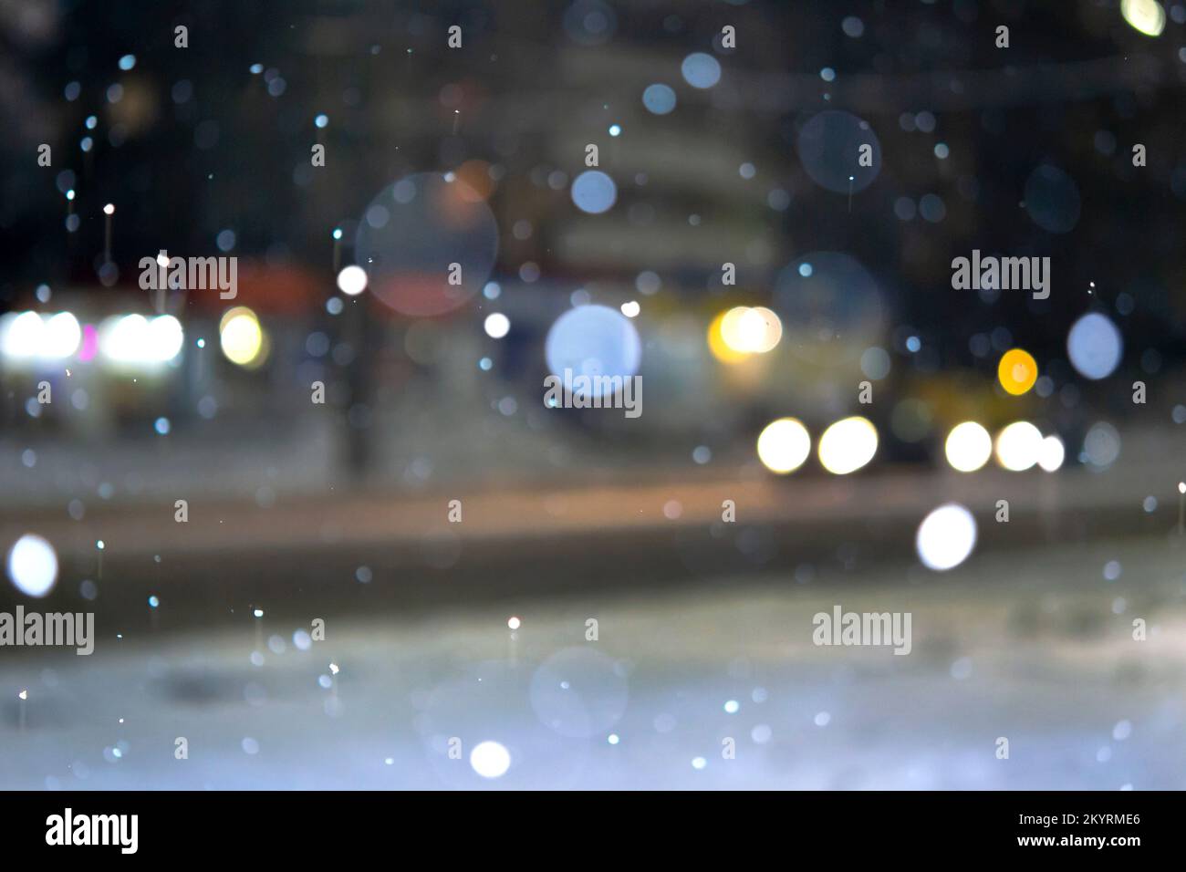 Blurred background. City view, lights, falling snow, night, street ...