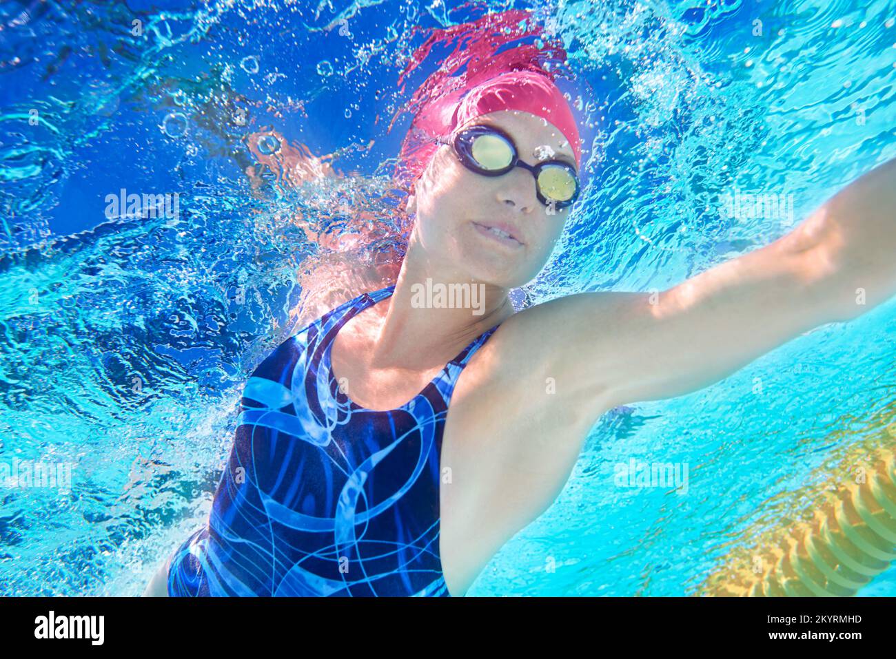 Swimming to a personal best. Underwater shot of a female swimmer Stock ...