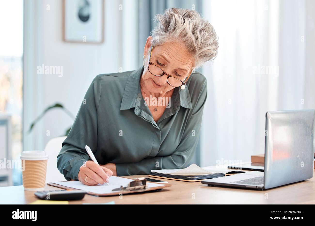 Writing, clipboard and laptop with a woman CEO or manager filling out ...