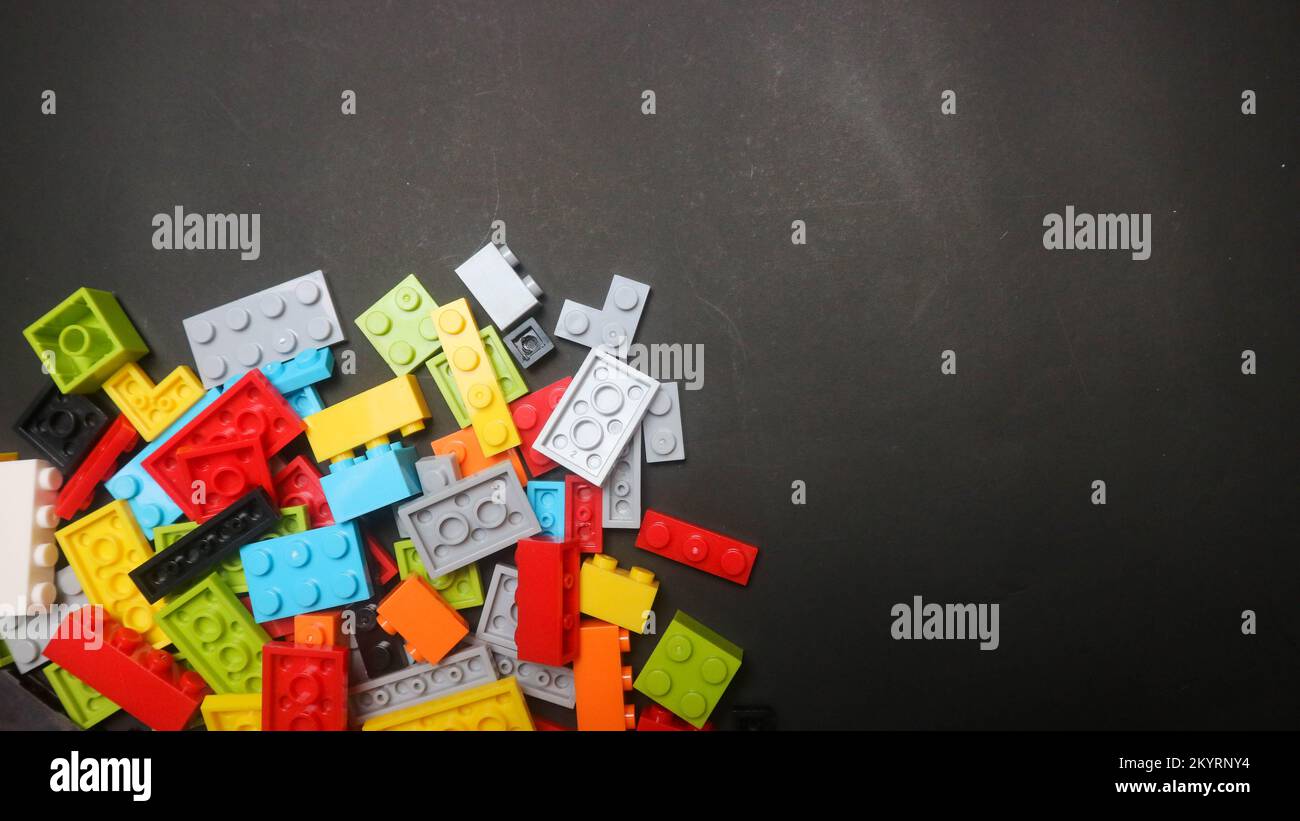 Plastic toy blocks on black background Stock Photo - Alamy