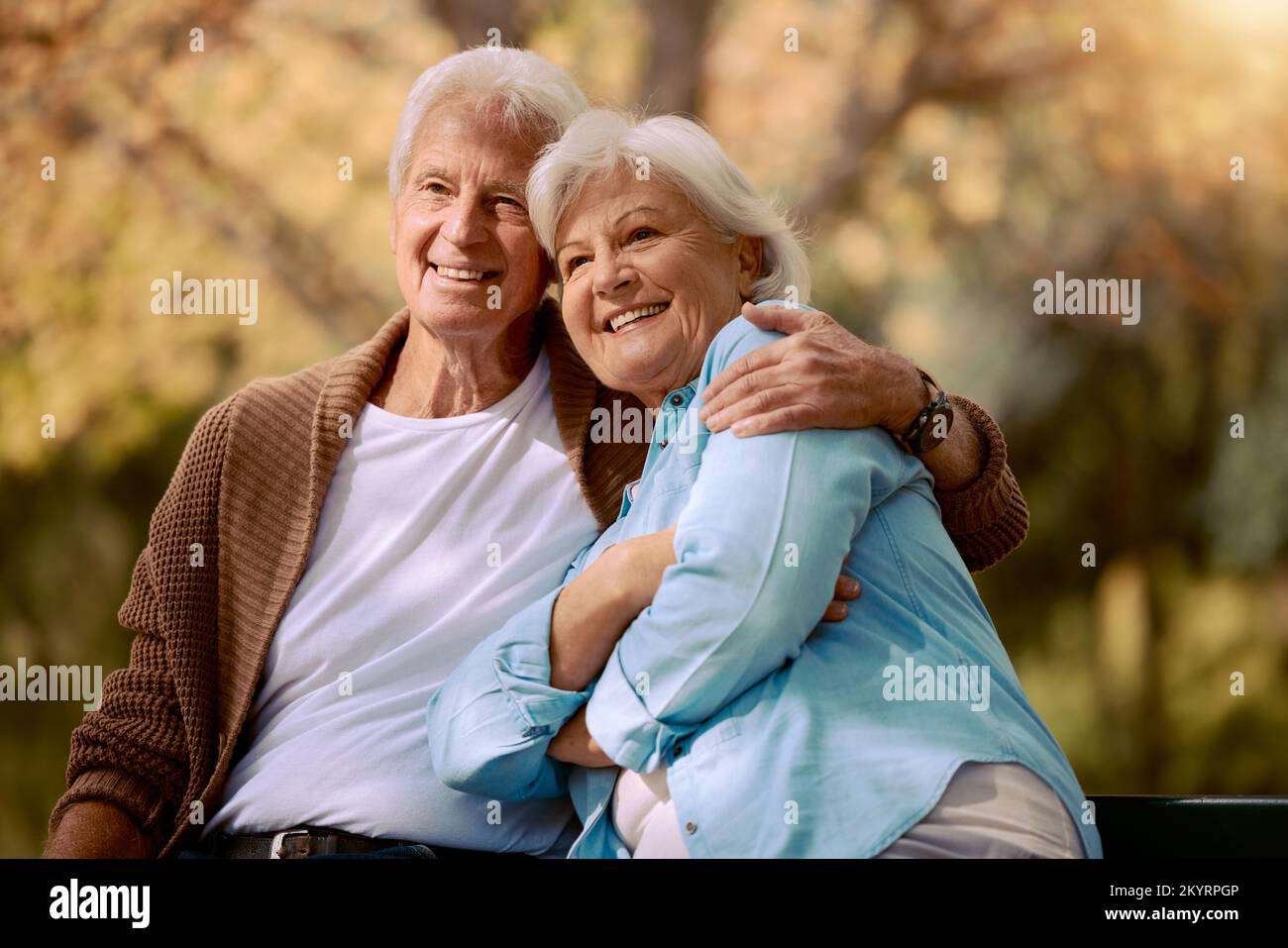 Elderly, couple hug in the park with love and happy in retirement ...