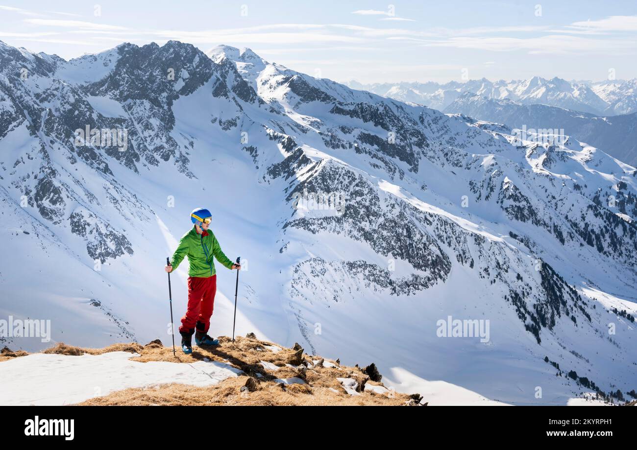 Hiker looking at Stubai Alps from Mitterzeigerkogel, mountains in ...