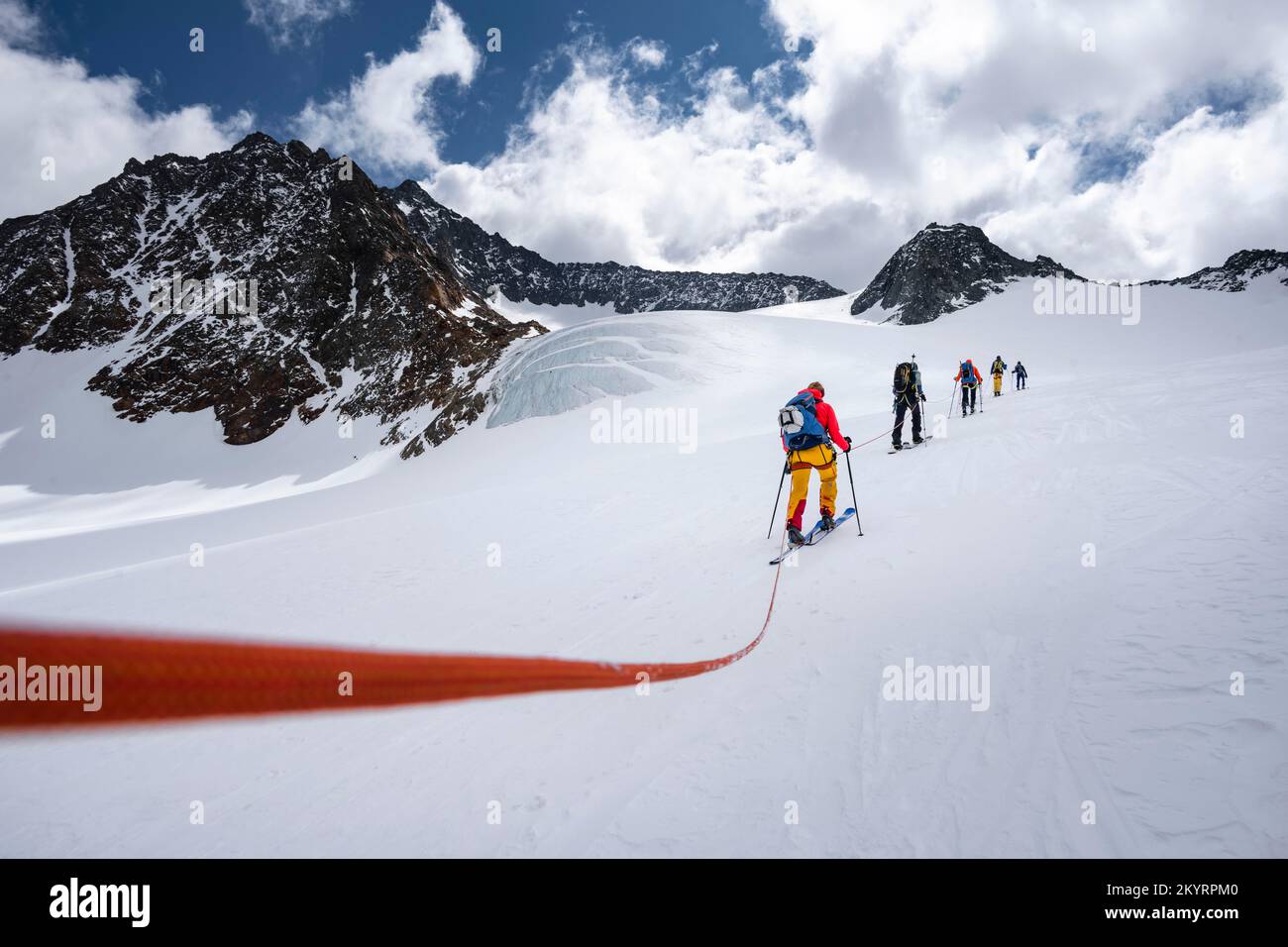 High altitude tour, ski tourers walking on a rope over Alpeiner Ferner ...