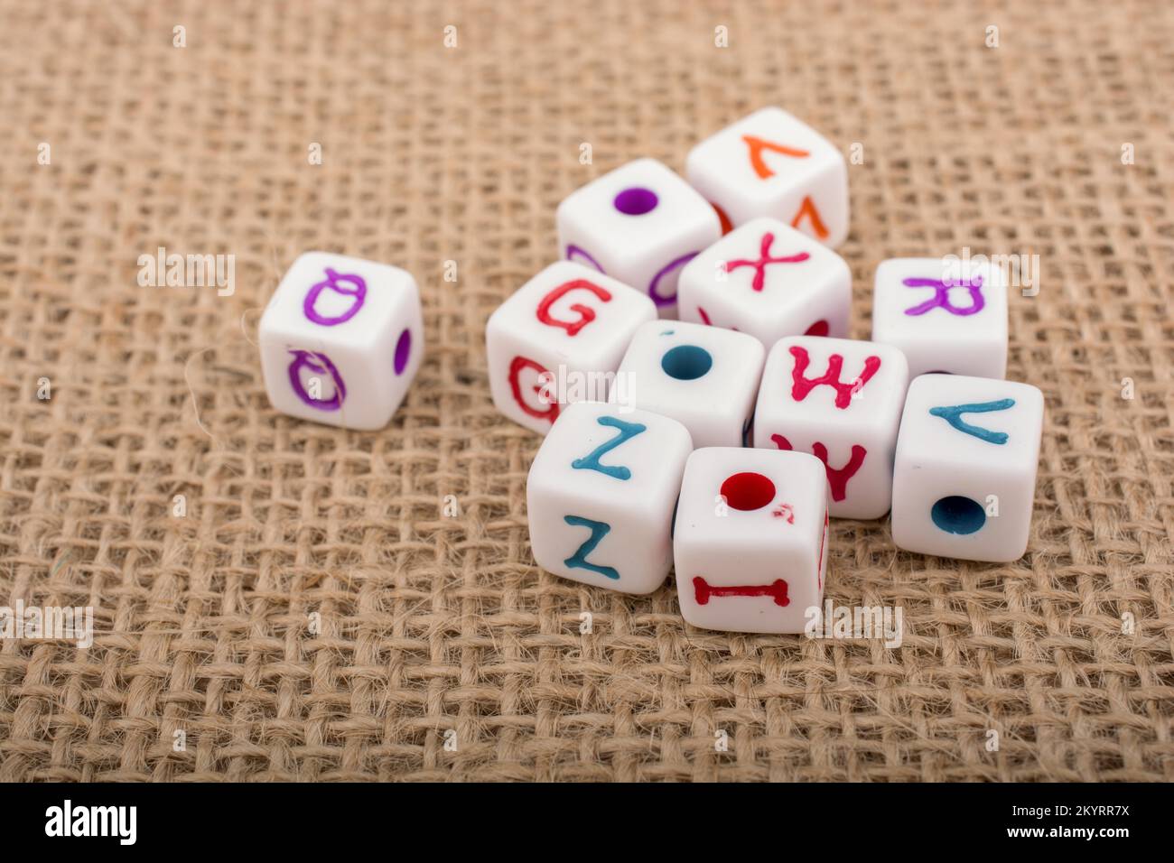 Colorful alphabet letter cubes on a linen canvas Stock Photo - Alamy