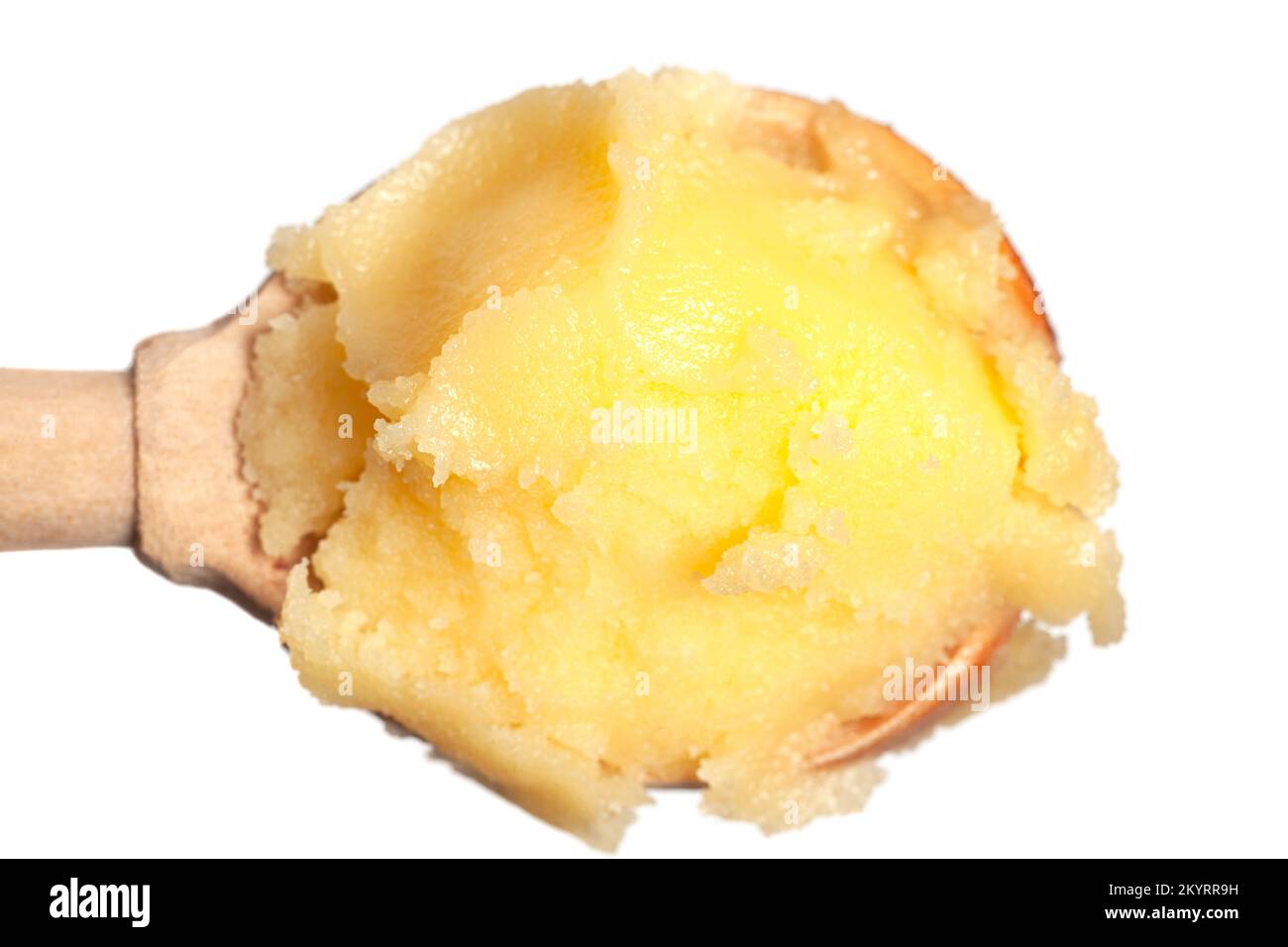 Ghee in wooden spoon isolated on white background Stock Photo - Alamy