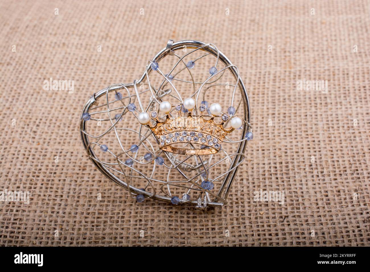 Golden color crown model with pearls on brown background Stock Photo ...