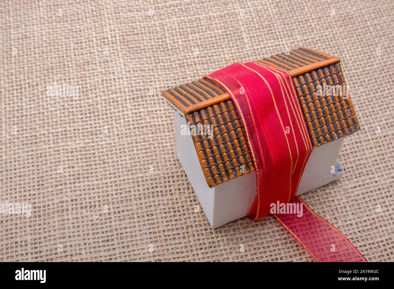 Pink band wrapped around a model house on a brown background Stock ...