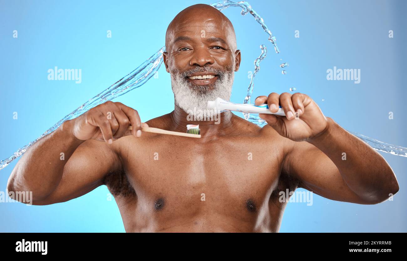 Toothbrush, bamboo and black man in studio with toothpaste, water splash and portrait for dental ...