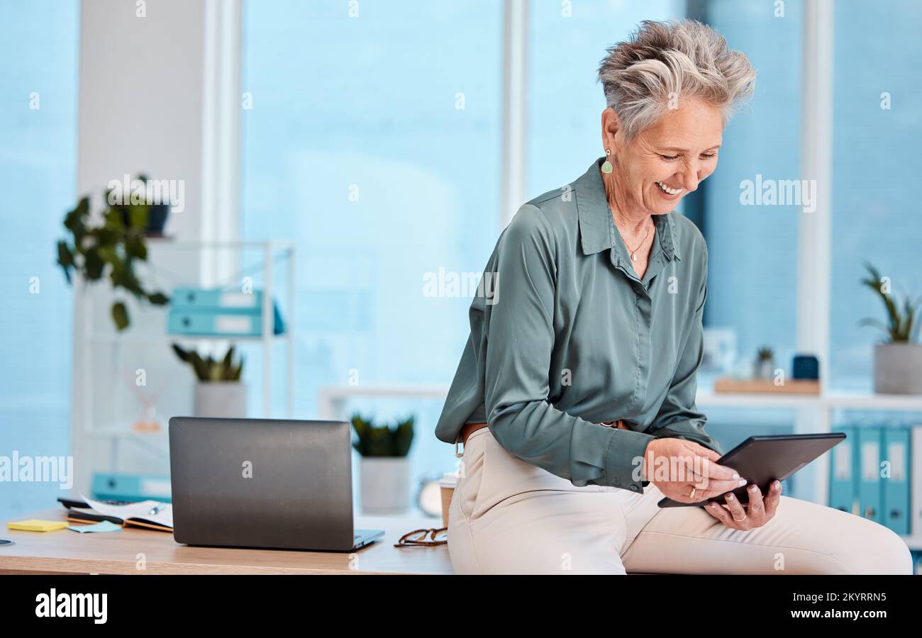 Senior, business woman and tablet in office for social media, internet ...