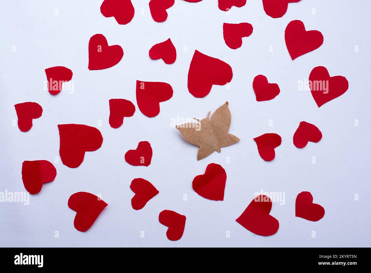 Paper butterfly and paper hearts in red color Stock Photo - Alamy