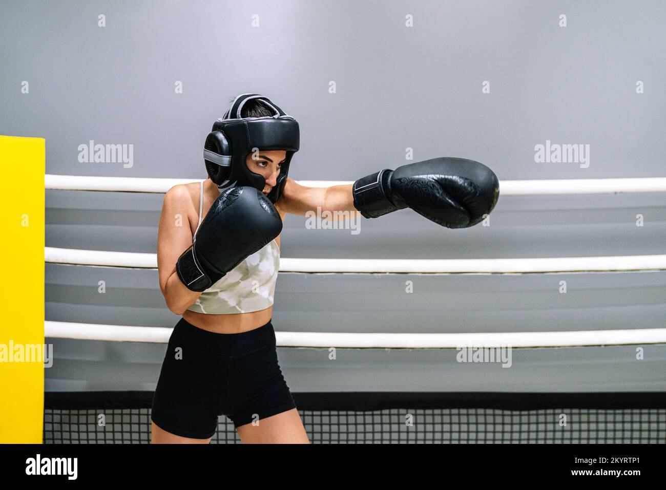 Young woman throwing a punch forward in a boxing ring Stock Photo - Alamy