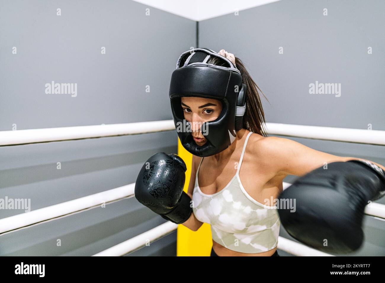 A boxer in position throwing a punch forward in a ring Stock Photo - Alamy