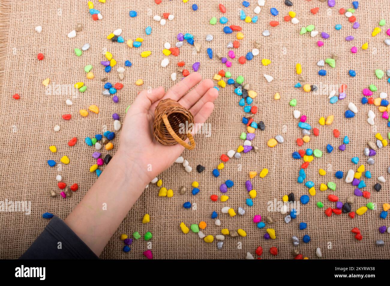 Bucket of colorful pebbles spill on background Stock Photo - Alamy
