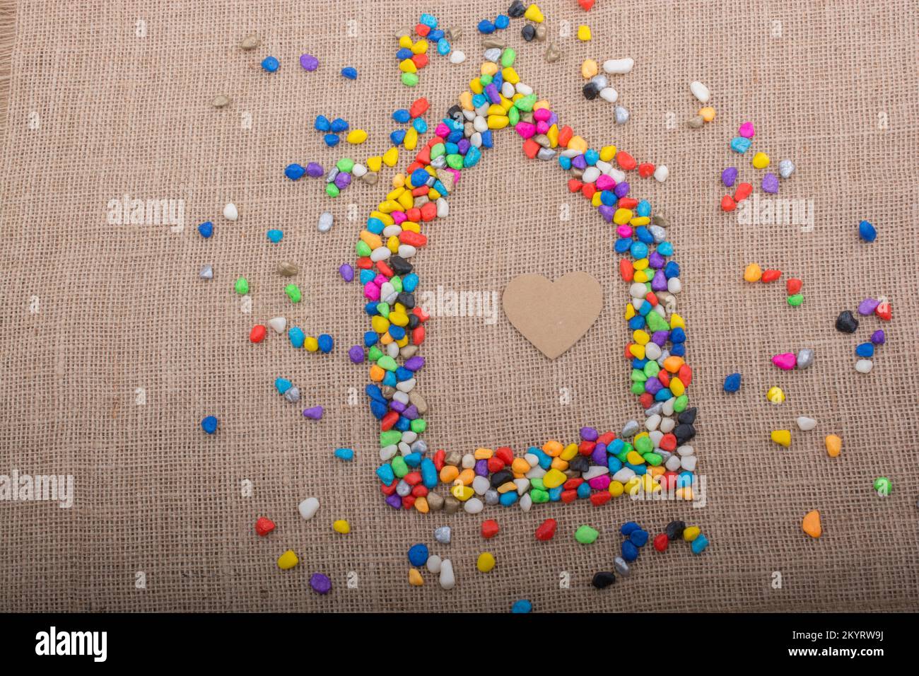 Heart in the house form shaped by colorful pebbles Stock Photo - Alamy