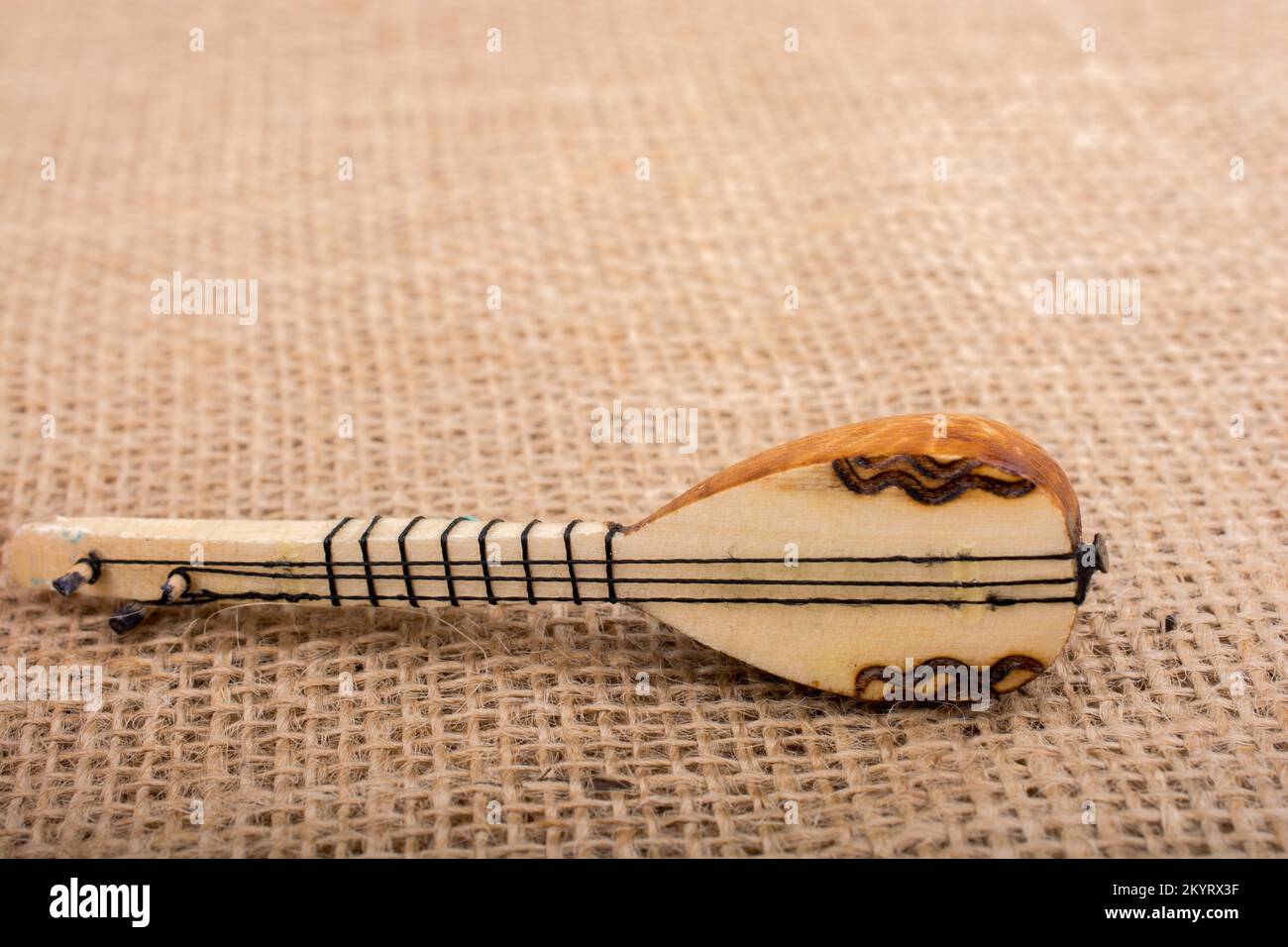 Model of Turkish musical instrument saz on a linen canvas Stock Photo ...