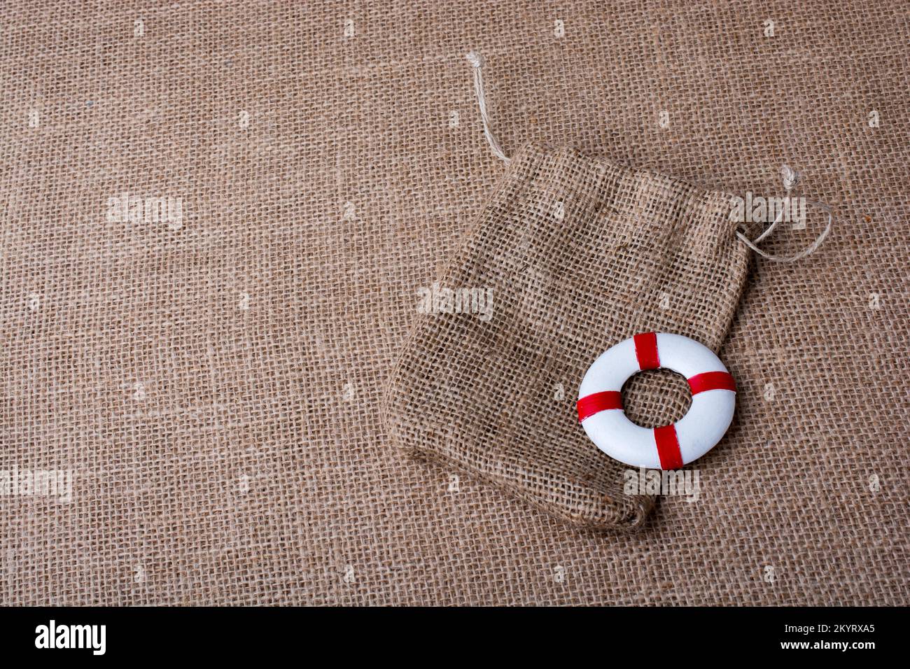 Life preserver on a sack on canvas background Stock Photo - Alamy