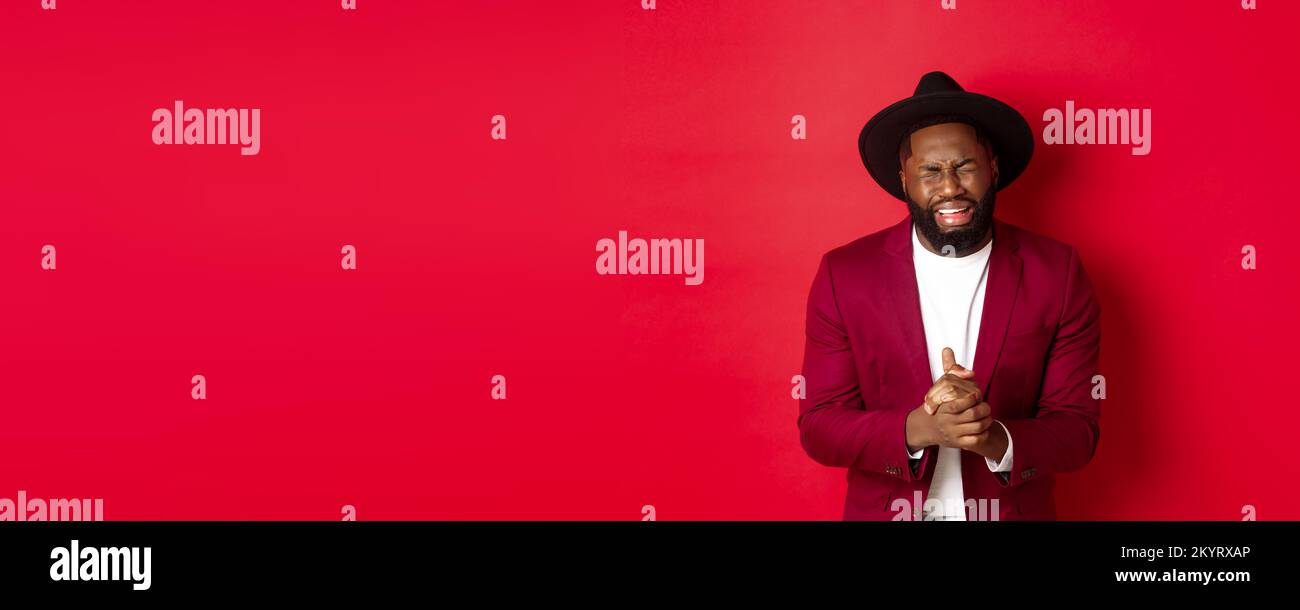 Miserable and heartbroken Black man crying, begging for help, holding ...