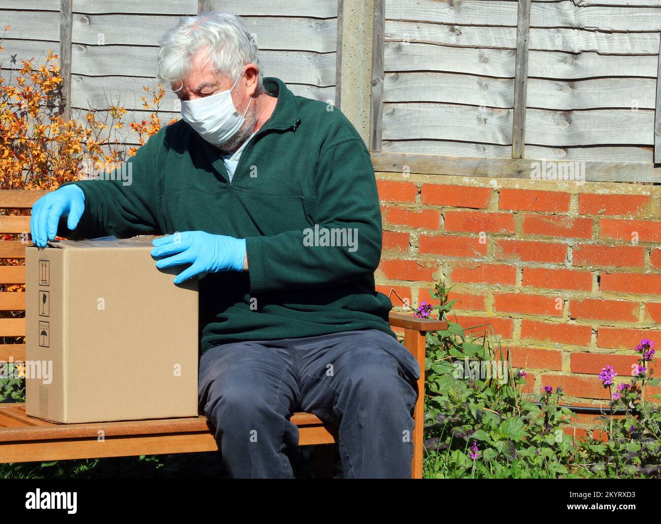 Elderly or senior person wearing a mask to prevent catching or passing ...