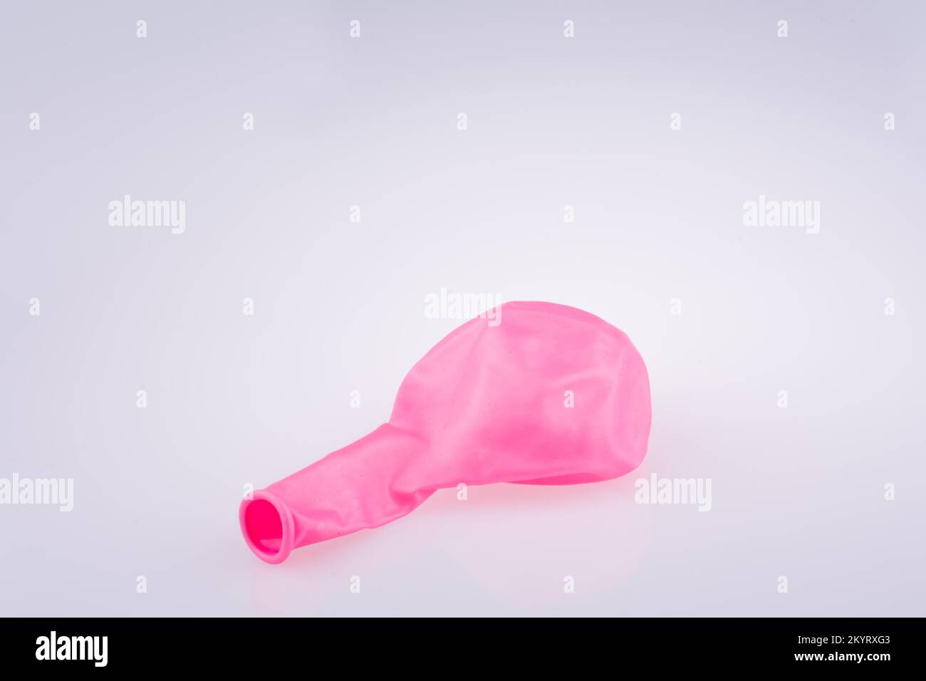 Empty red balloon on a white background Stock Photo - Alamy