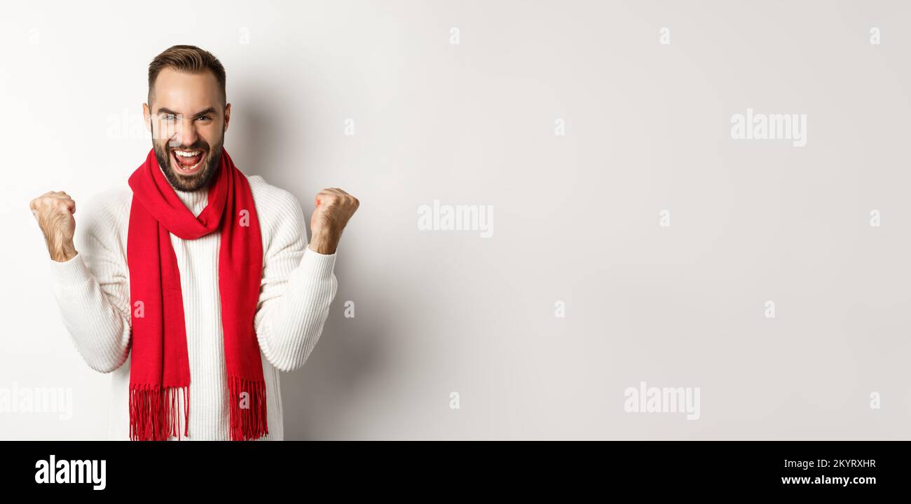 Christmas holidays and New Year concept. Happy man celebrating victory ...