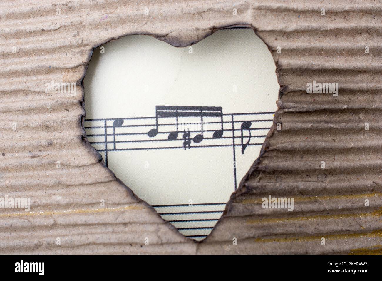 Musical notes and heart shaped burnt out of a brown cardboard Stock ...