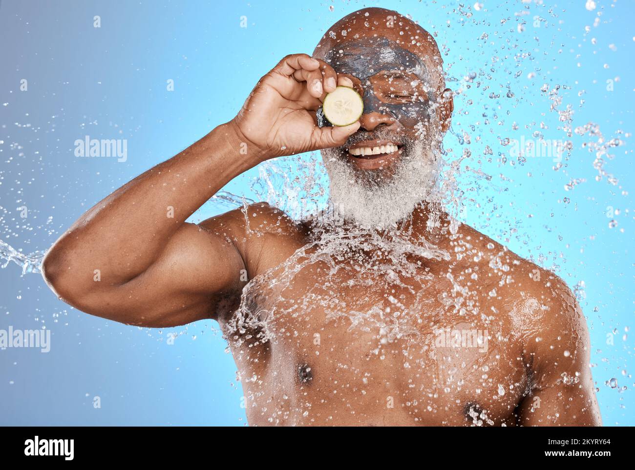 Facial, water splash and black man in studio for skincare, beauty and wrinkles treatment on blue ...
