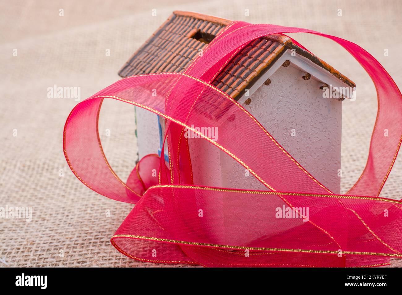 Pink band wrapped around a model house on a brown background Stock ...