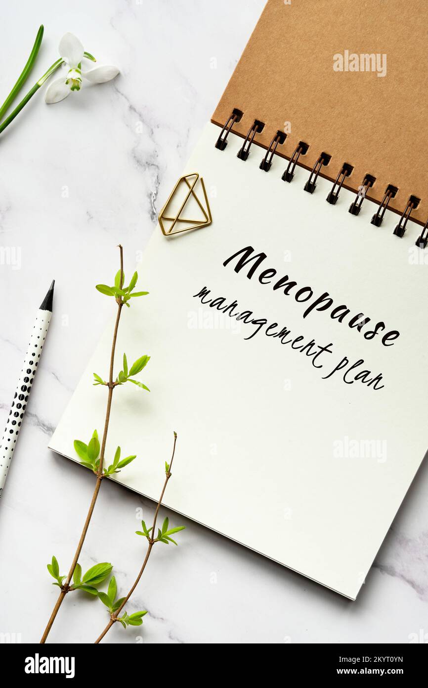 Menopause management plan, text in notebook with spiral binder. Caption ...