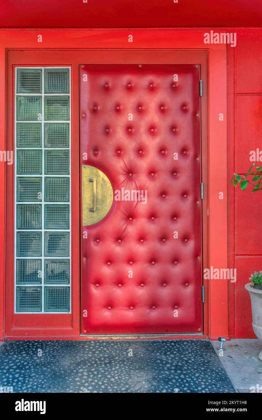 Bright red upholstered door at the entrance of a restaurant in Austin ...