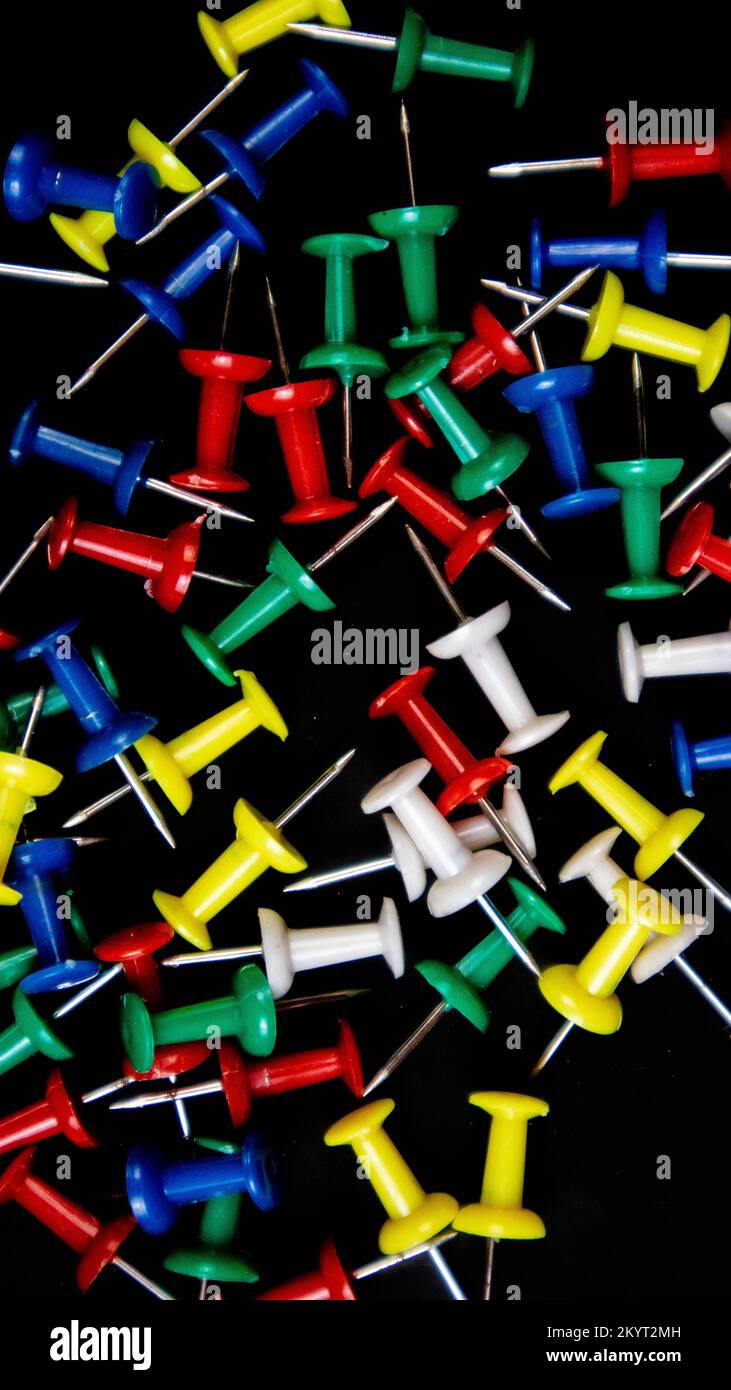 colorful thumbtacks on black background Stock Photo - Alamy