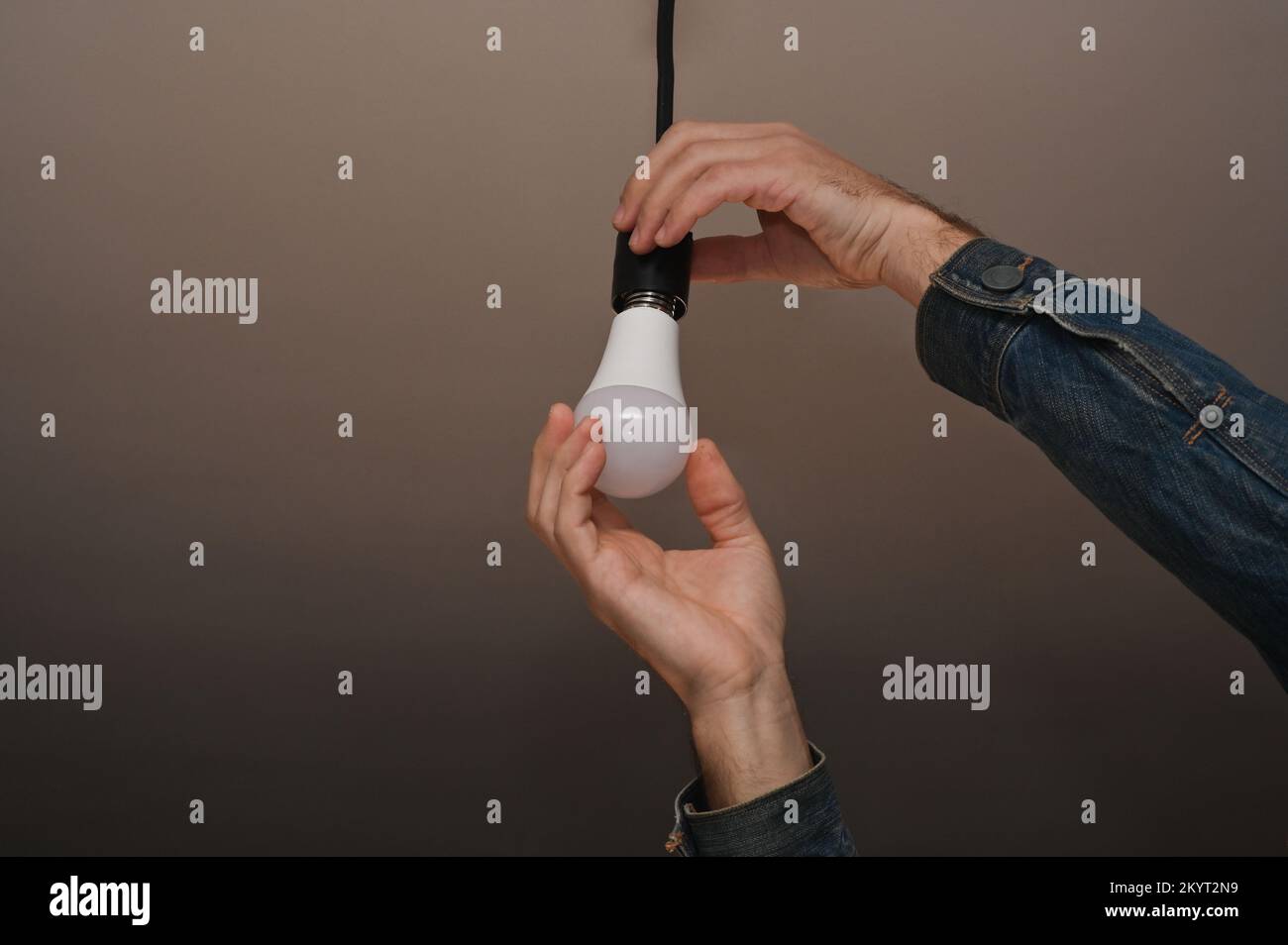 Electric LED Light bulb. Replacing the lamp with LED lamps Stock Photo ...