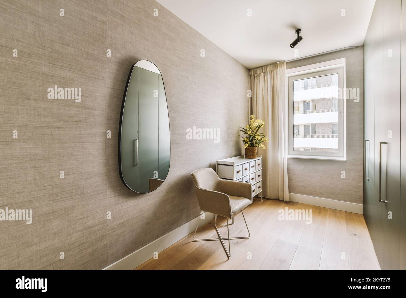Modern cupboard and vintage chest placed near doors and wicker basket ...